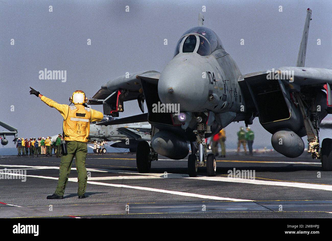 An F-14B Tomcat aircraft of Fighter Squadron 74 (VF-74) is directed ...