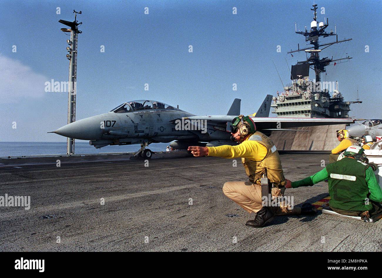 The launch officer gives the signal to launch an F-14B Tomcat aircraft ...