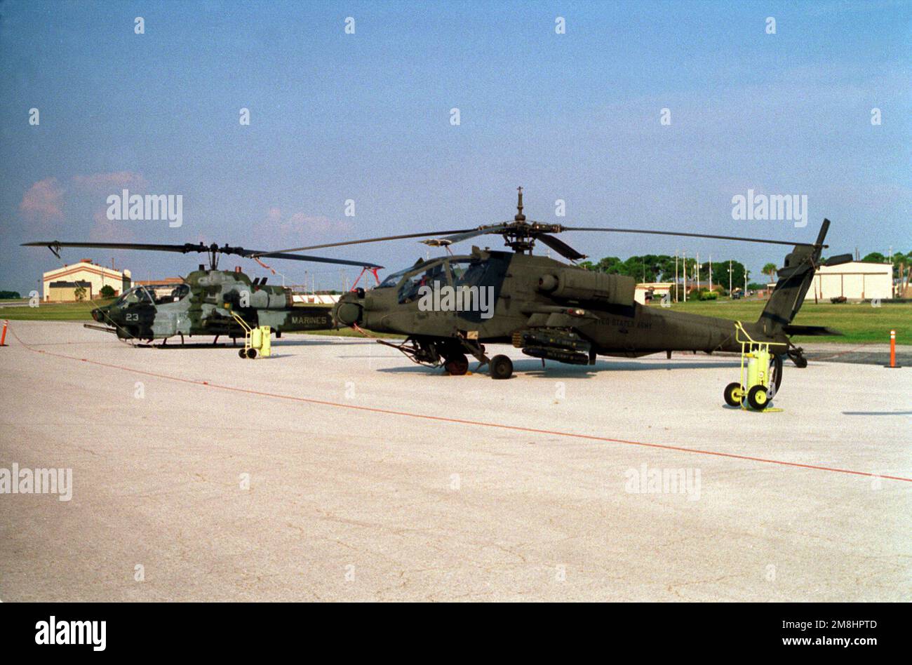 A left front view of a U.S. Army Ah-64A Apache helicopter parked next ...