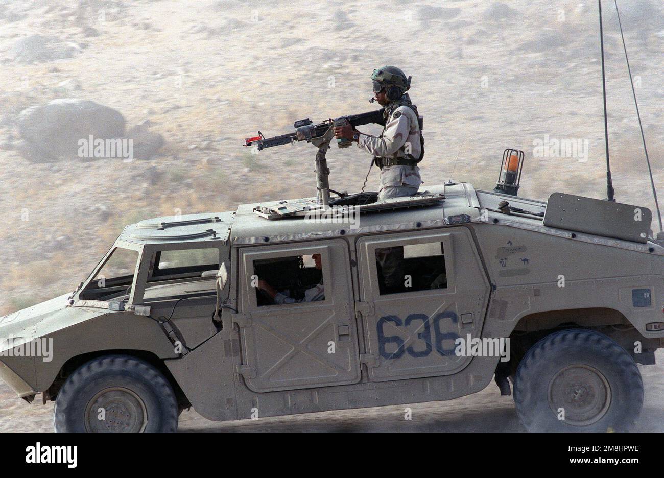 Sergeant David Price runs the machine gun in a High-Mobility ...