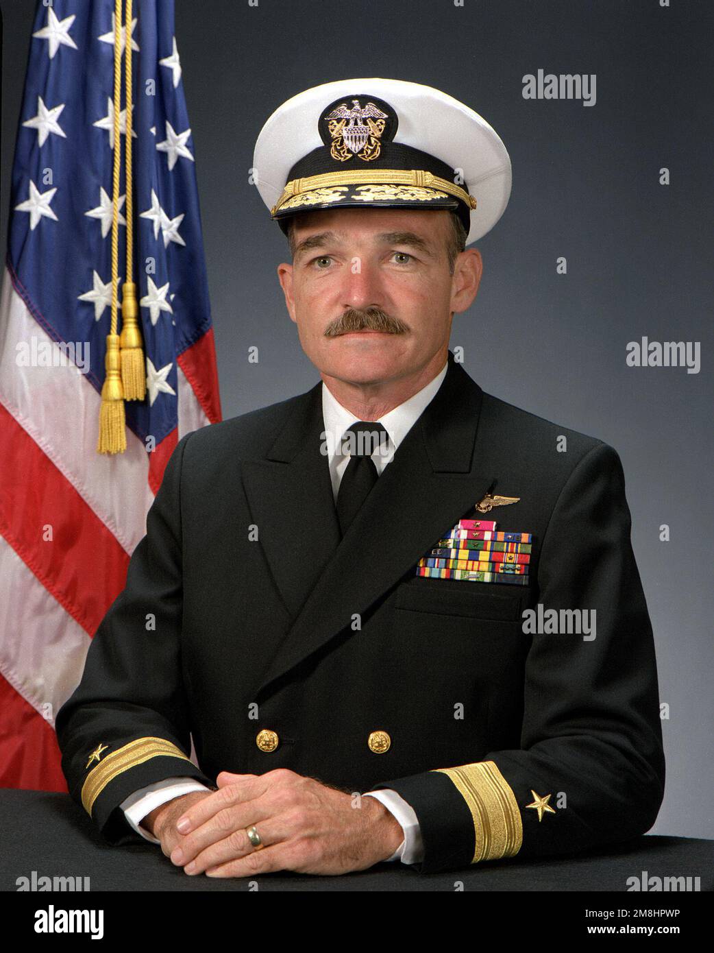 Rear Adm. (lower half) Dennis V. McGinn, USN (covered). Country ...