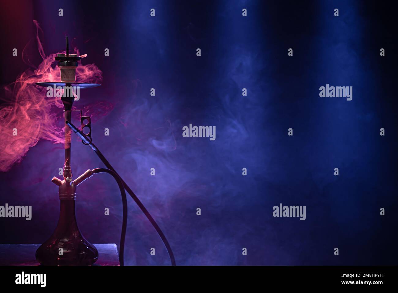 The classic hookah. Beautiful background, with colored rays of light and smoke. The concept of ...