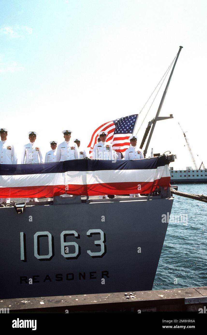 Officers stand on the stern of the frigate USS REASONER (FF 1063) as ...