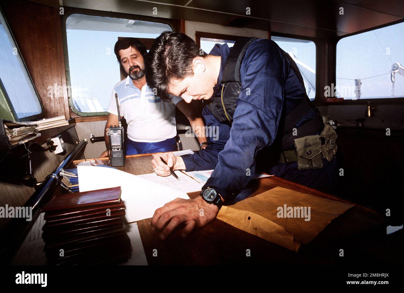 LT. j.g. Manning, USS NORMANDY's (CG-60) boarding officer, inspects the ...