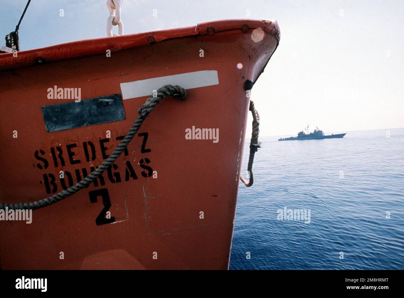 The guided missile cruiser USS NORMANDY (CG-60) stands by off the port ...
