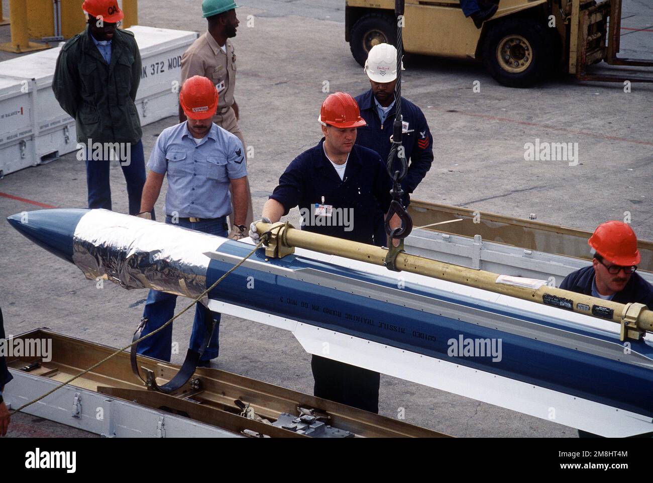Members of the Weapons Division prepare to remove a new Mark 66 Mod 3 ...
