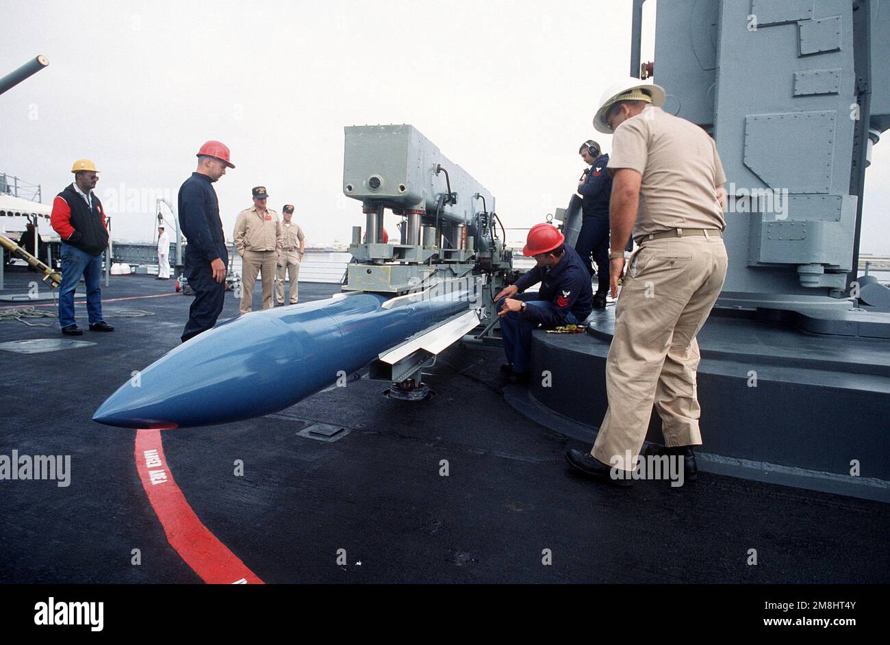Members of the Weapons Division check the loading arm attachments as ...