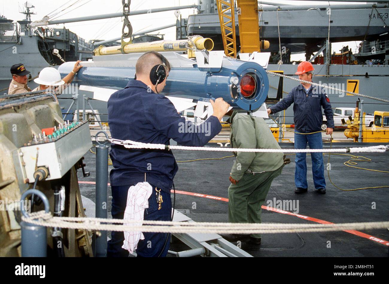 Members of the Weapons Division guide a new Mark 66 Mod 3 guided ...