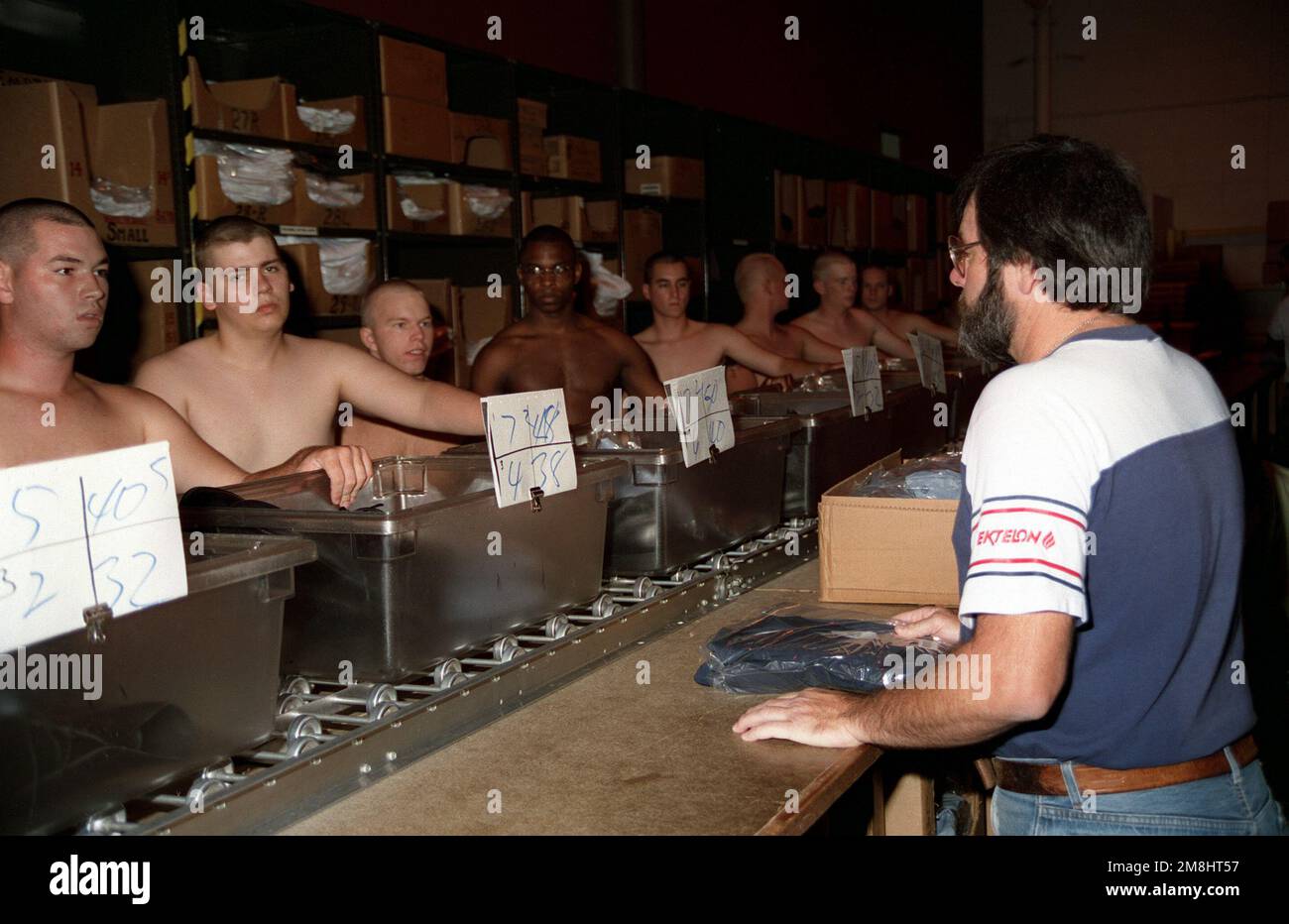 New recruits of Company 215 receive their uniform issue, assembly line ...