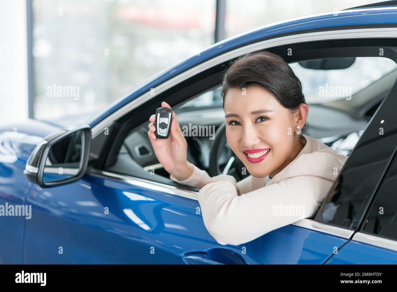 A young business woman driving Stock Photo - Alamy