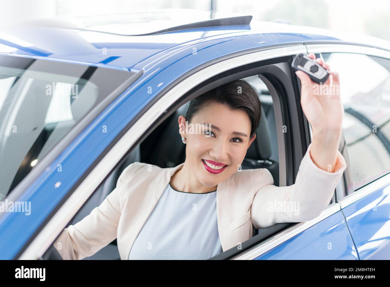 A young business woman driving Stock Photo - Alamy