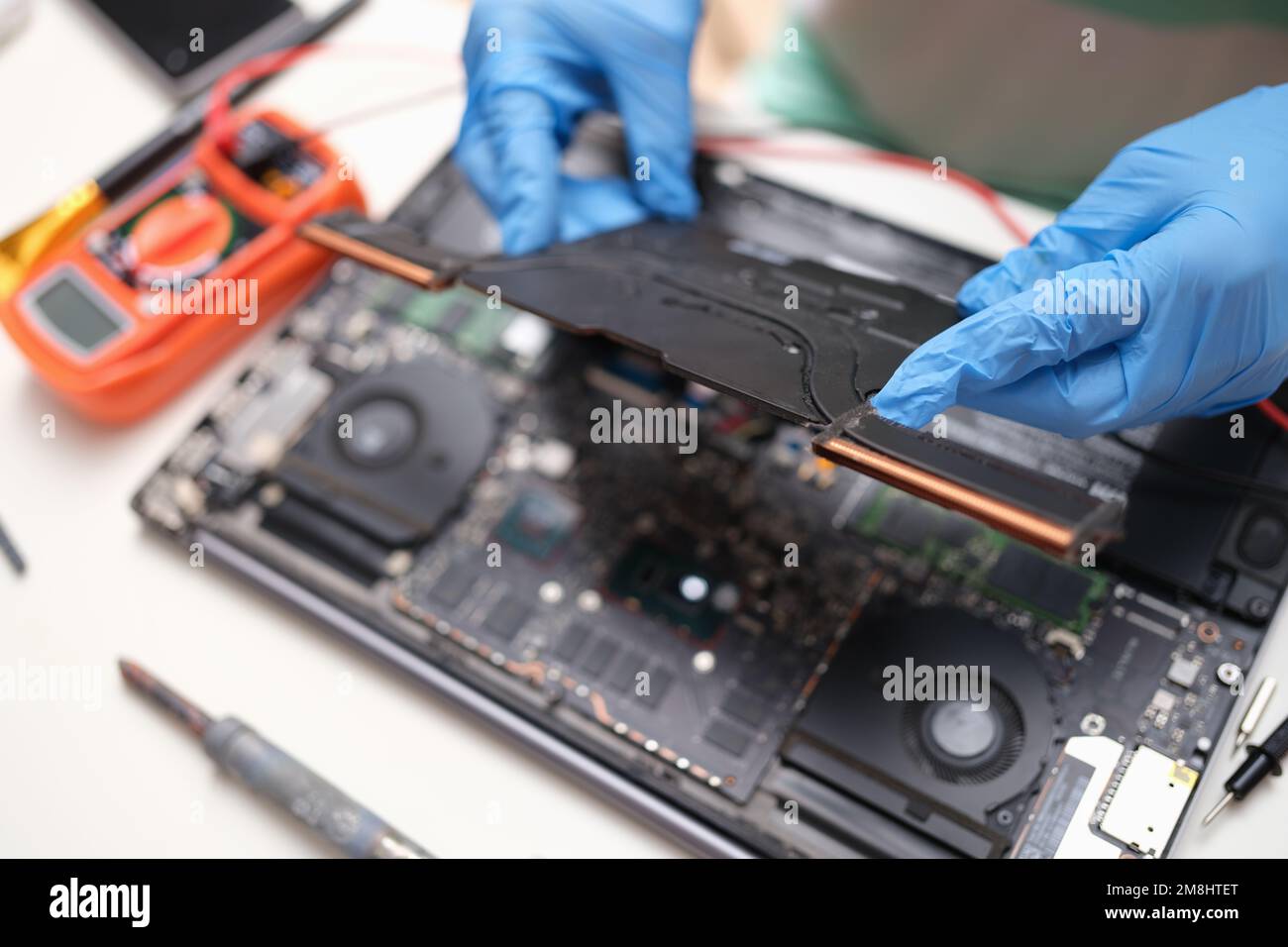 PC repair technician with laptop on background of hardware technologies ...