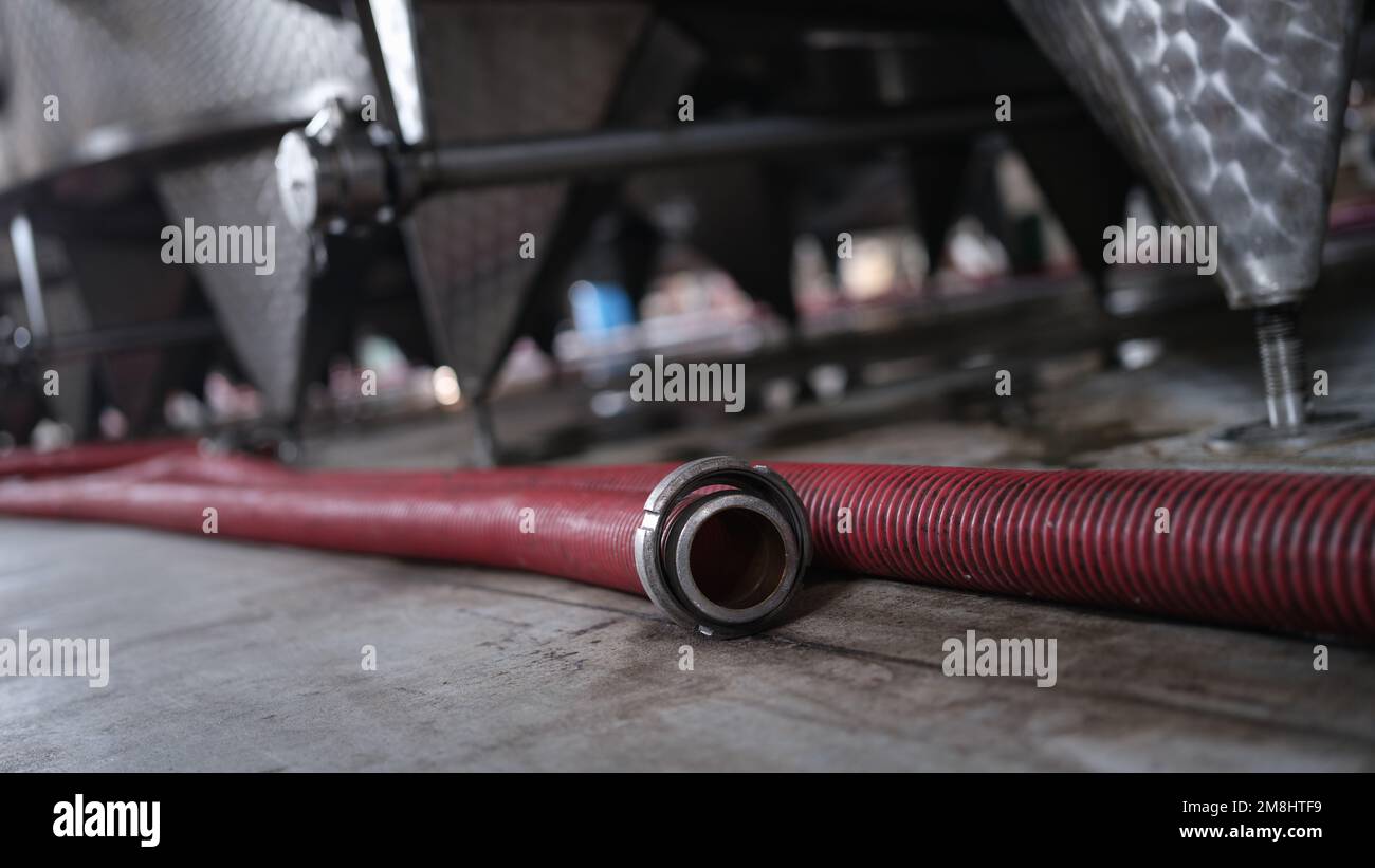 Red rubber hose lies on floor in industrial factory Stock Photo - Alamy