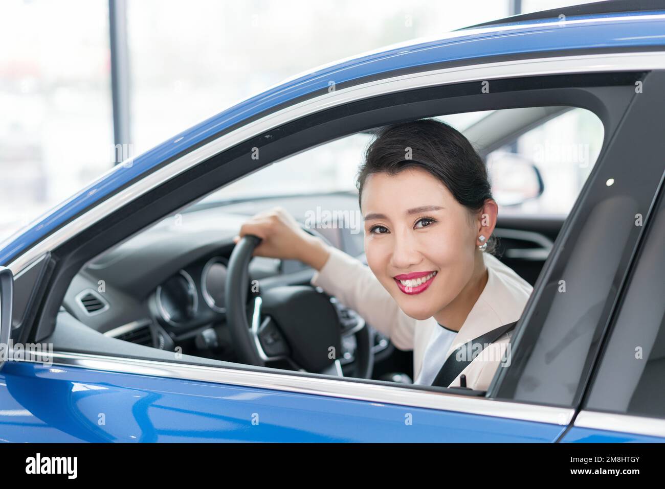 A young business woman driving Stock Photo - Alamy