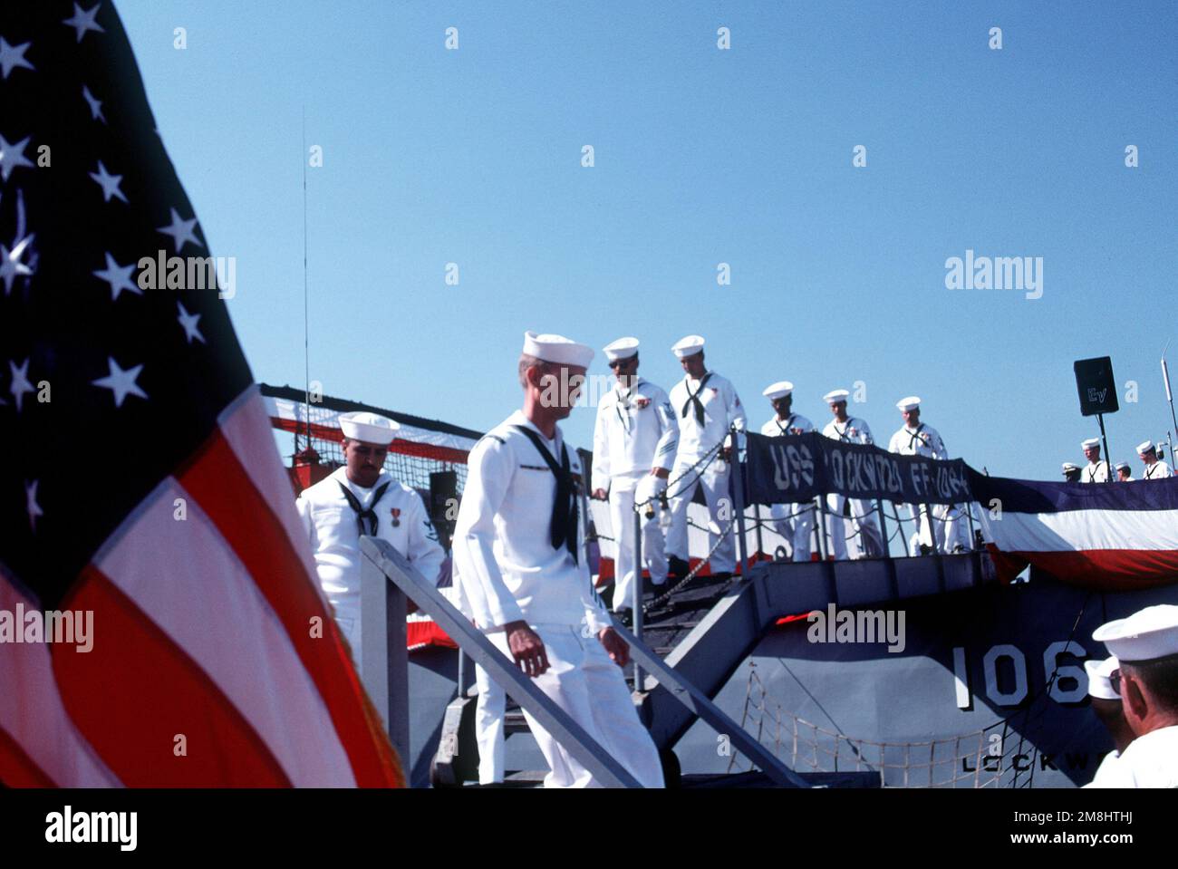 Crew members disembark from the frigate USS LOCKWOOD (FF-1064) during ...