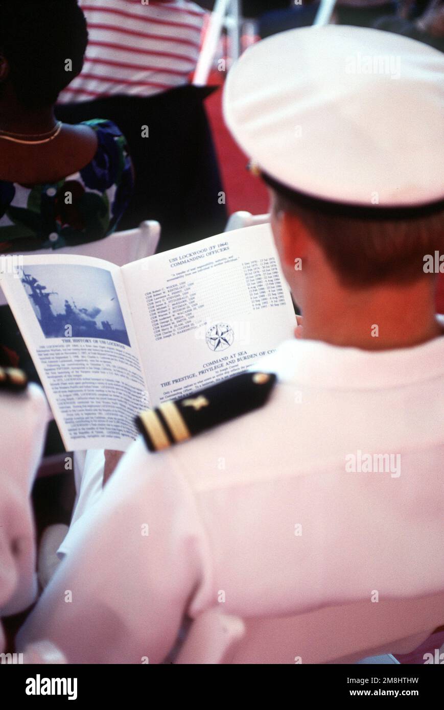 An officer reads the program pamphlet during the decommissioning ...