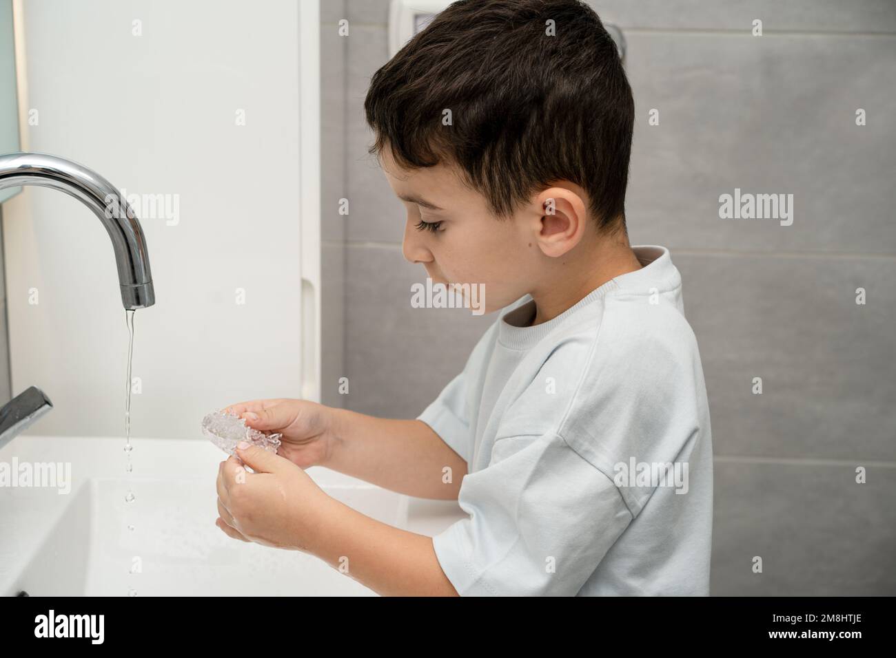Child wash grown crystal. Science experiment on growing crystals in ...