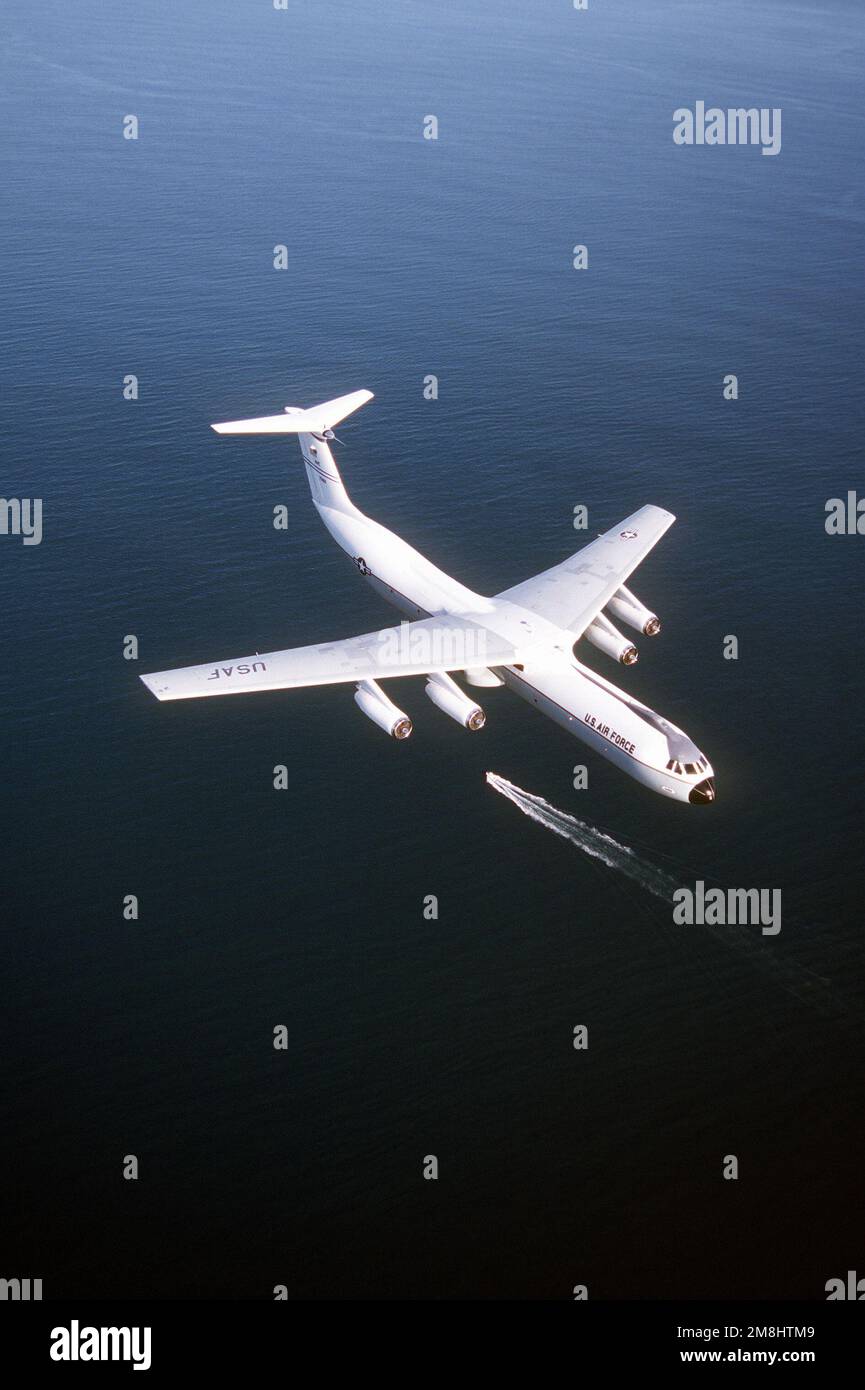 An air-to-air side view of a 438th Airlift Wing, C-141 Starlifter ...