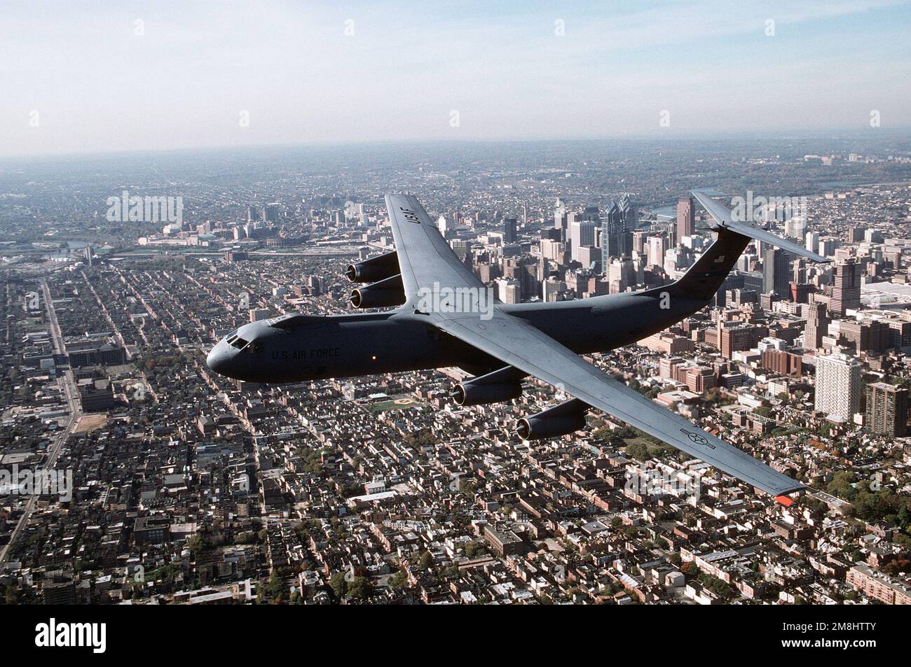 An air-to-air left side view of a 438th Airlift Wing, C-141 Starlifter ...