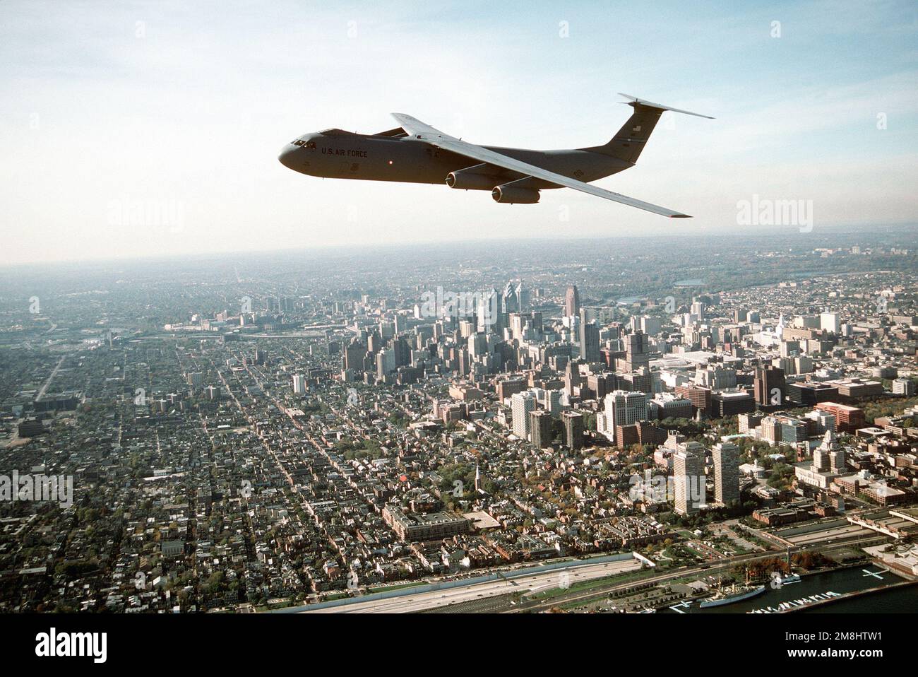 An air-to-air left side view of a 438th Airlift Wing, C-141 Starlifter ...