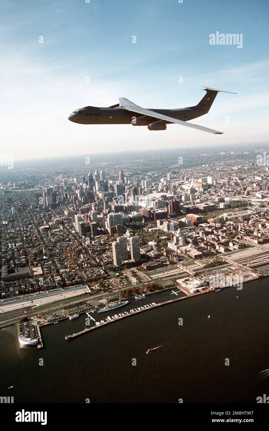 An air-to-air left side view of a 438th Airlift Wing, C-141 Starlifter ...