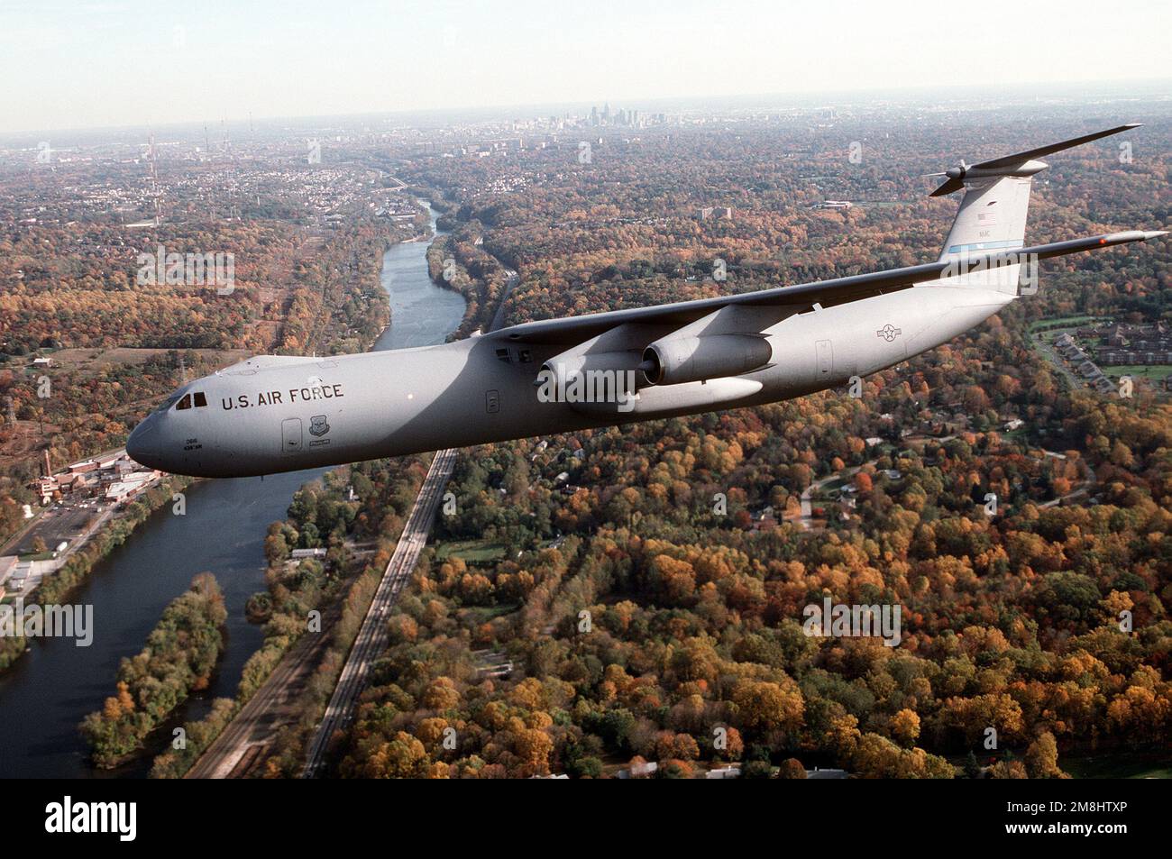 An air-to-air left side view of a 438th Airlift Wing, C-141 Starlifter ...