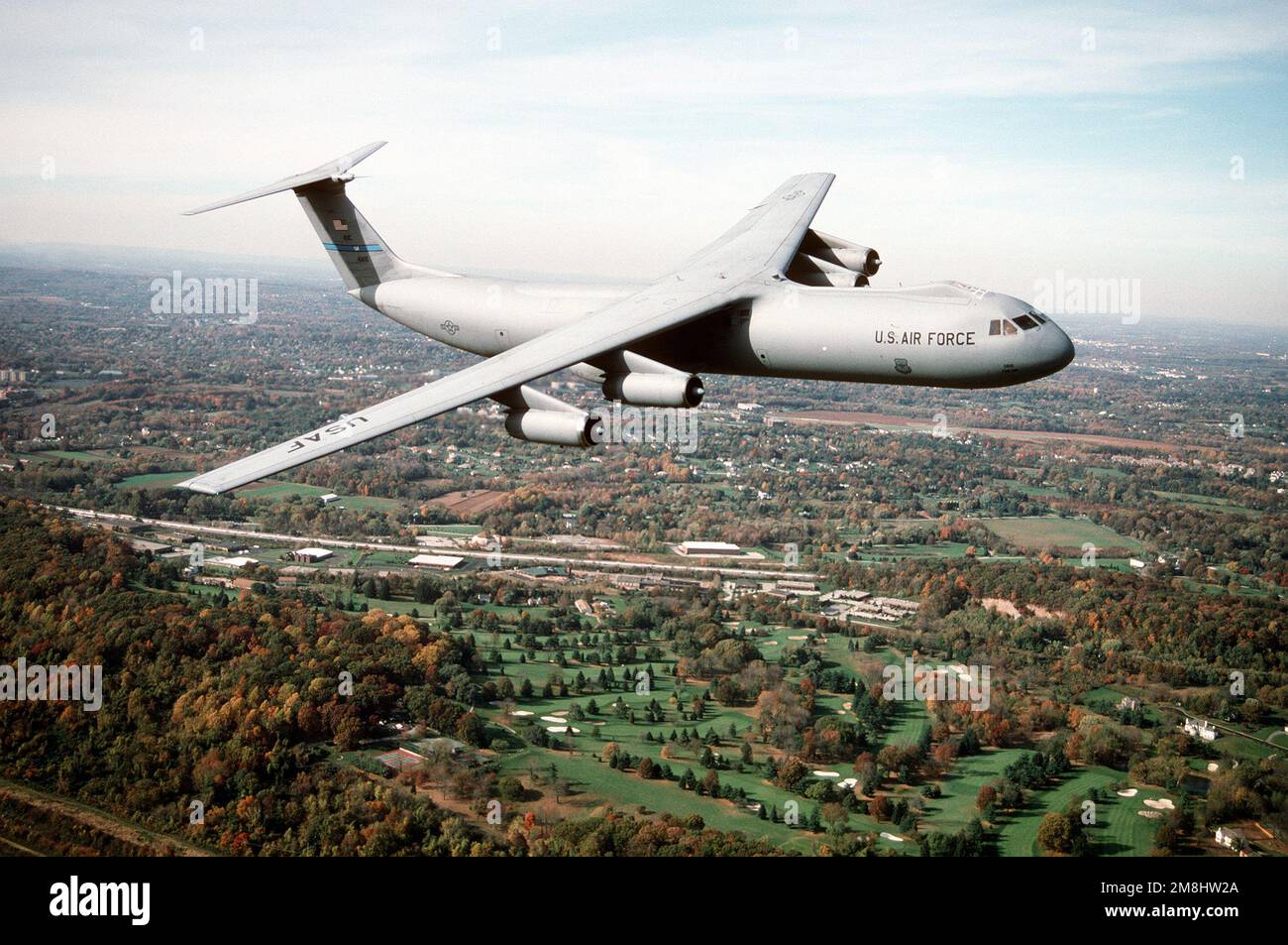 An air-to-air right side view of a 438th Airlift Wing, C-141 Starlifter ...