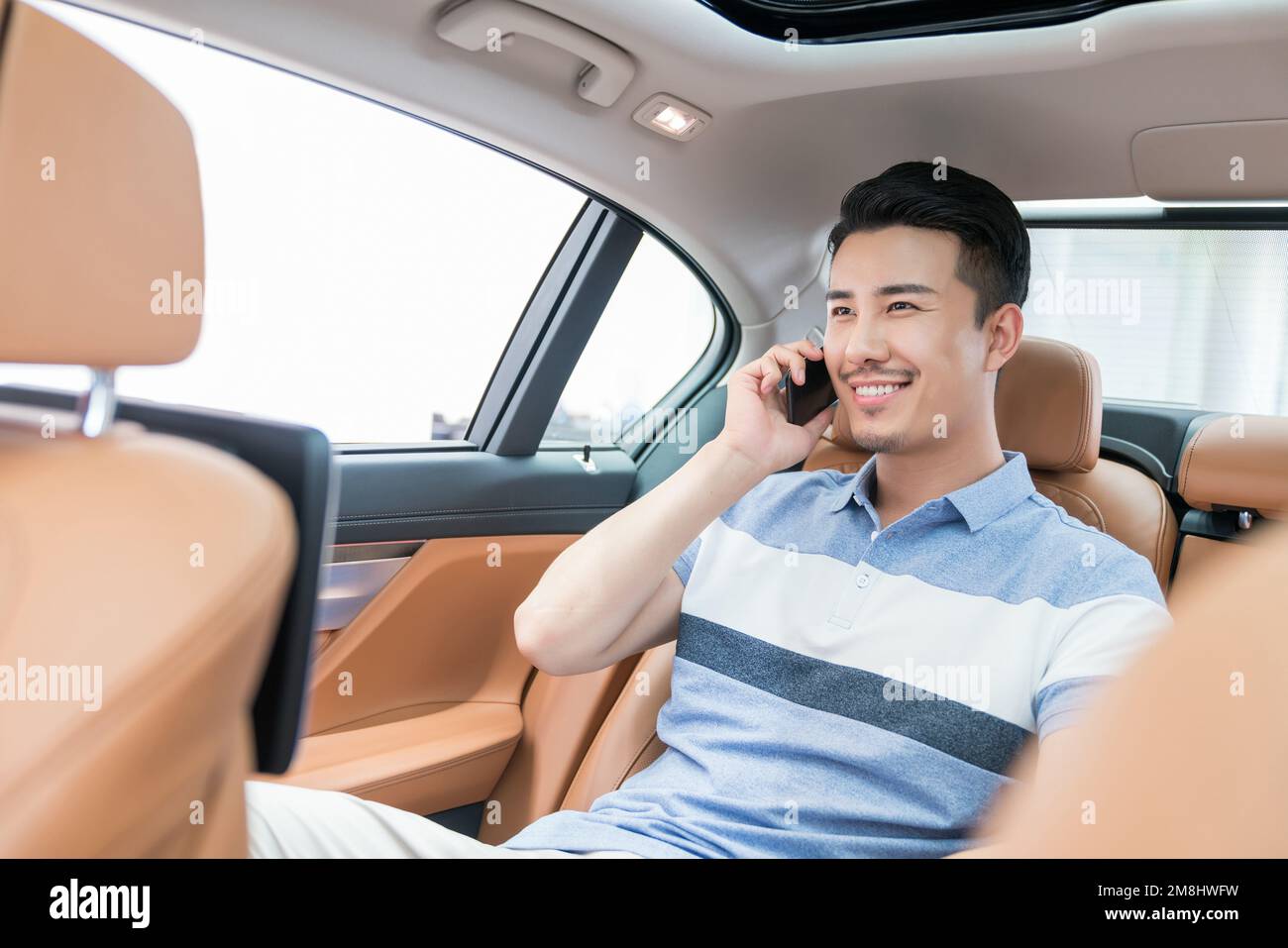 Business man in the car to use mobile phones Stock Photo - Alamy