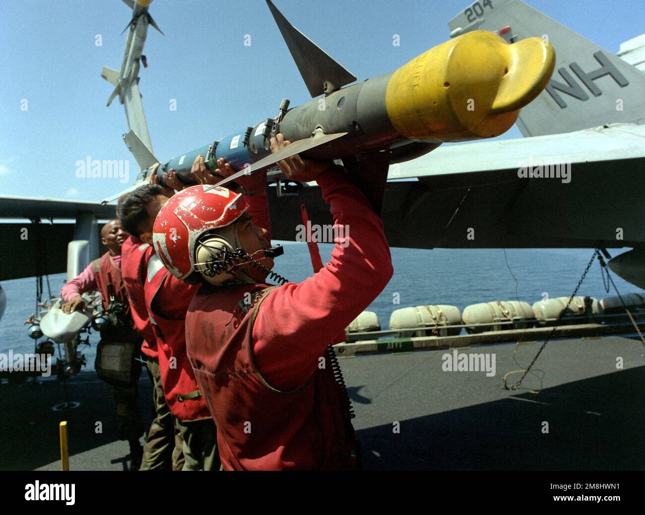 Ordnance personnel of Strike Fighter Squadron (VFA-94) are shown ...
