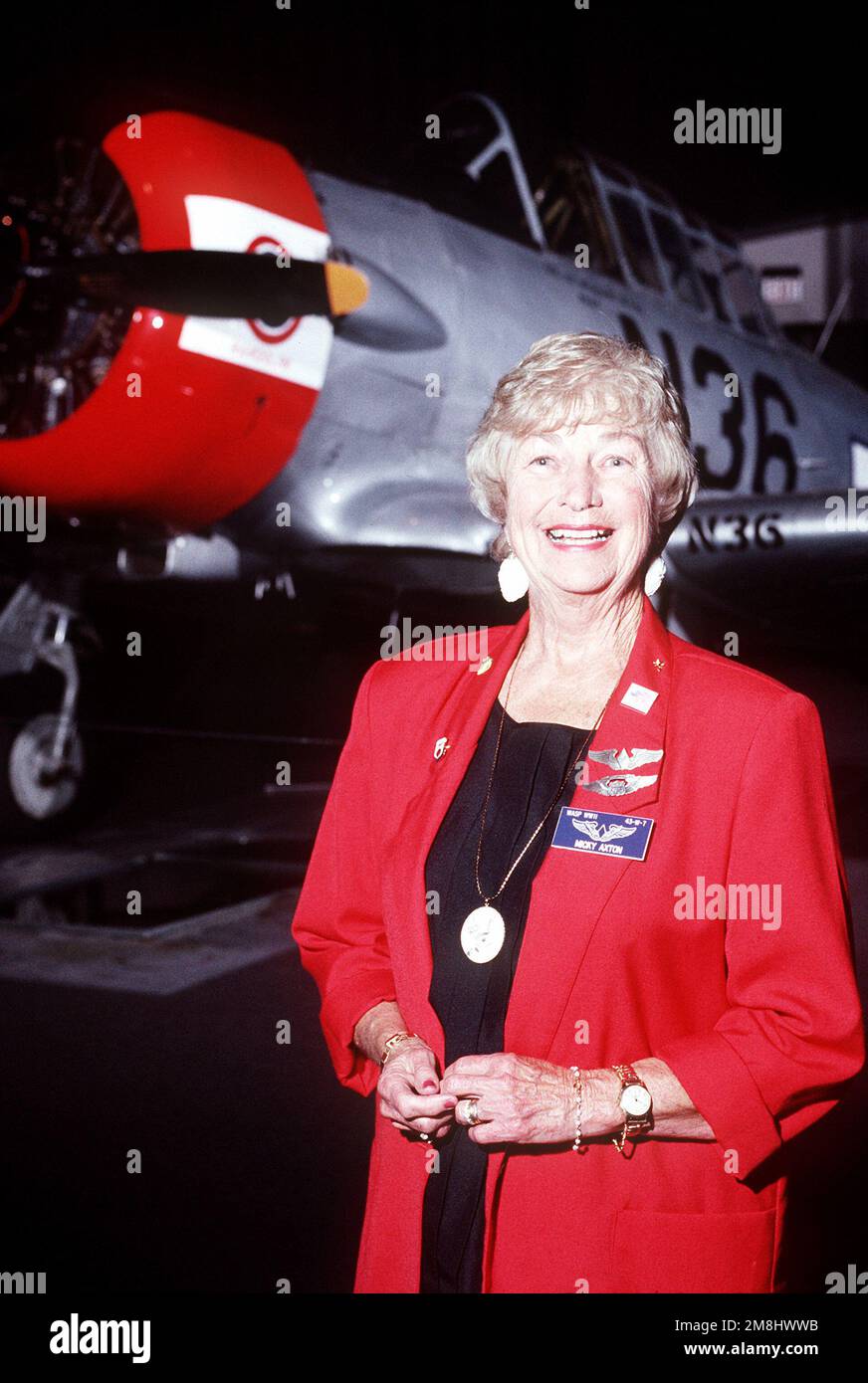 Micky Axton poses in front of an AT-6 at the Confederate Air Force ...
