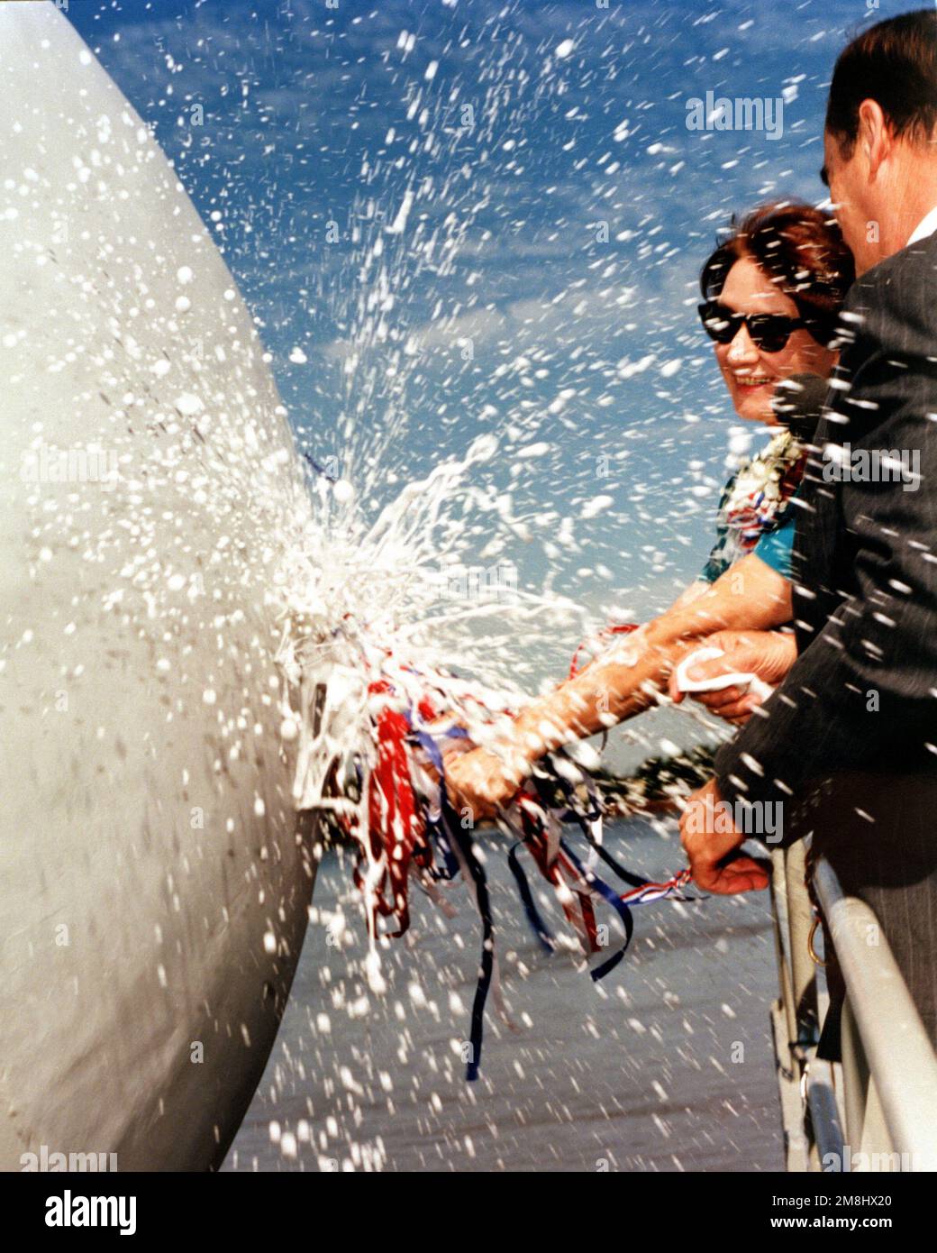 Mrs. Mary Elam Howard, ship's sponsor, breaks the traditional of ...