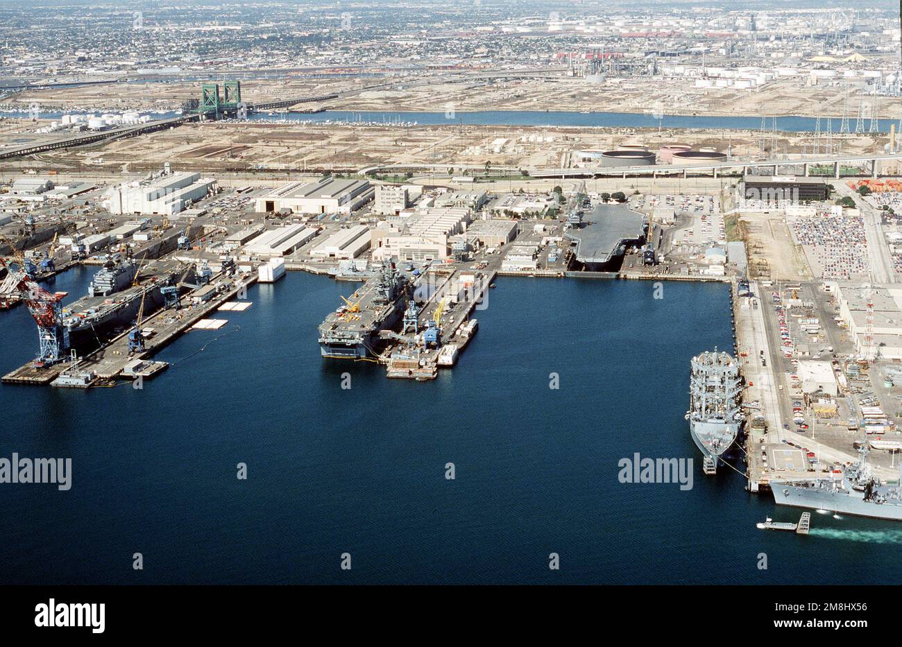 An aerial view of the amphibious assault ships USS TARAWA (LHA-1), left ...
