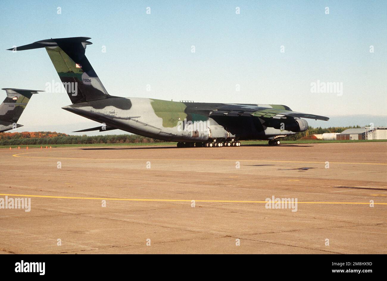 A C-5 aircraft, loaded with troops and cargo, prepares to take off for ...