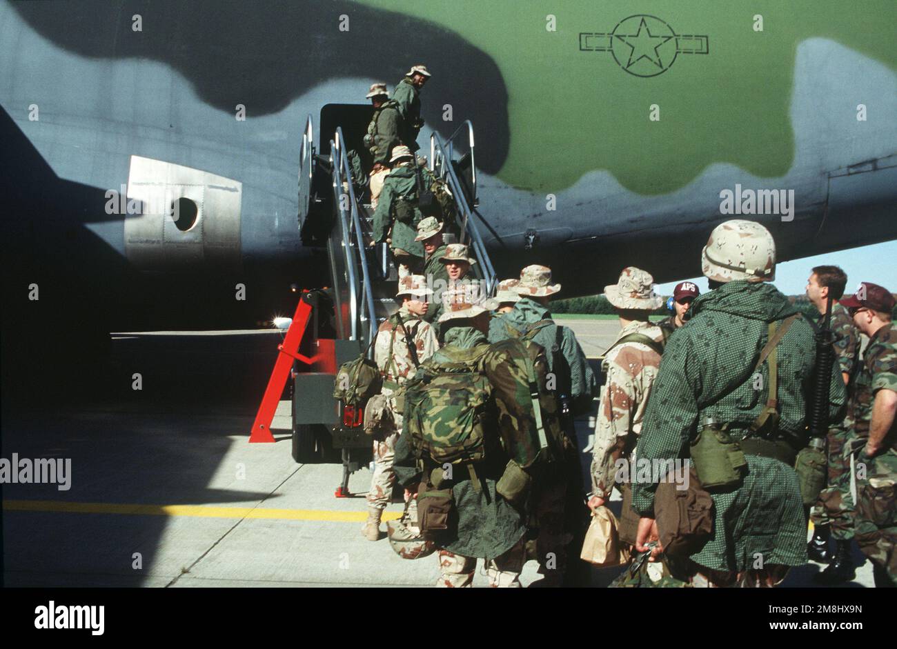Troops climb aboard a C-5 aircraft in preparation for deployment to Mogadishu, Somalia. Subject ...