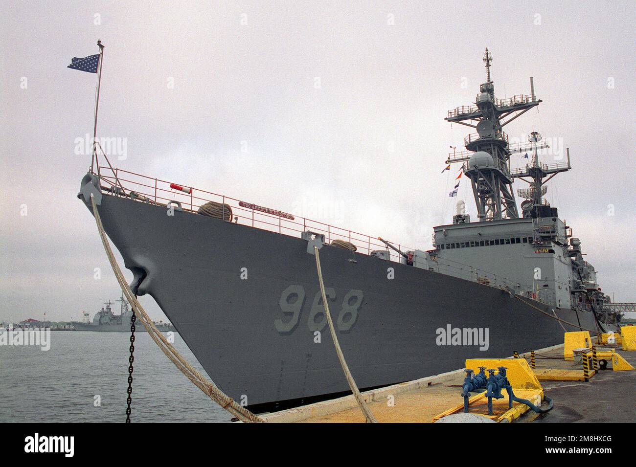 A port bow view of the destroyer USS ARTHUR W. RADFORD (DD-968) tied to ...