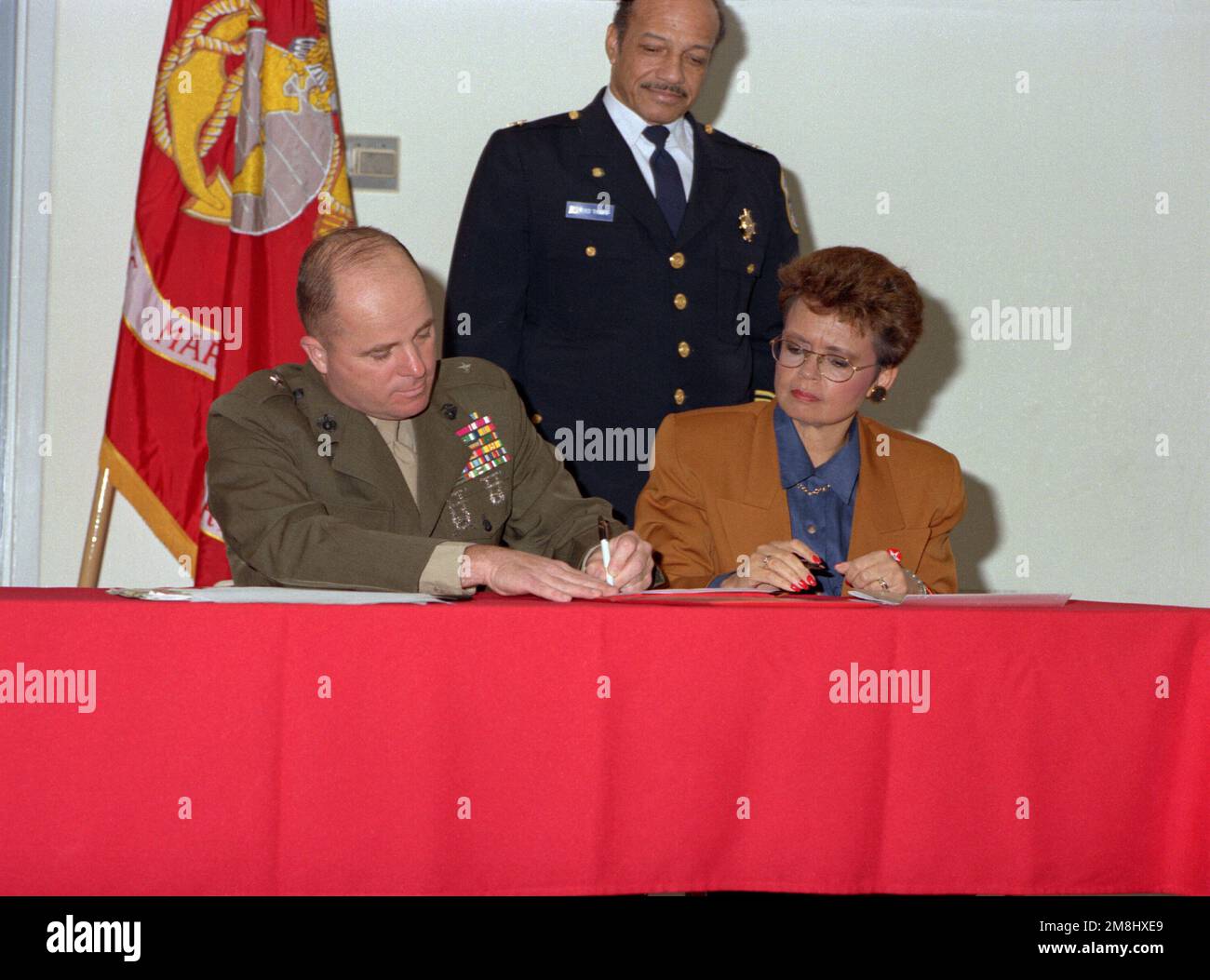 Mayor Sharon Pratt Kelly watches as Brig. GEN. Steele signs an ...