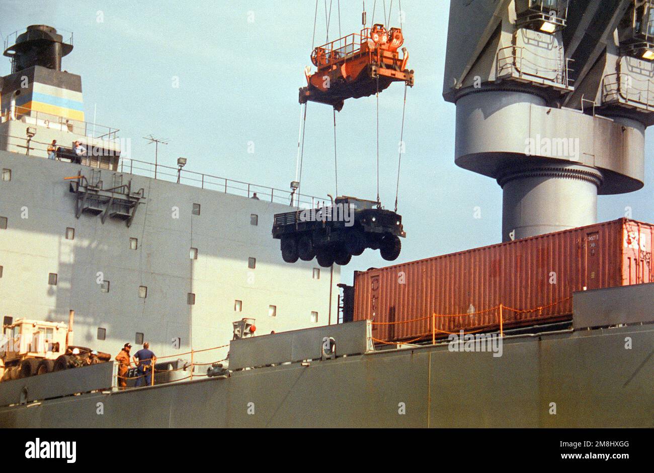 Two and a half ton family of medium tactical vehicle, being loaded on ...