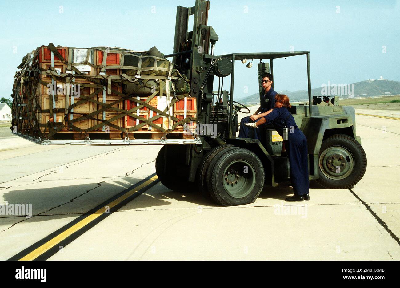 Navy Personnel using a rough terrain forklift down load Marine ...