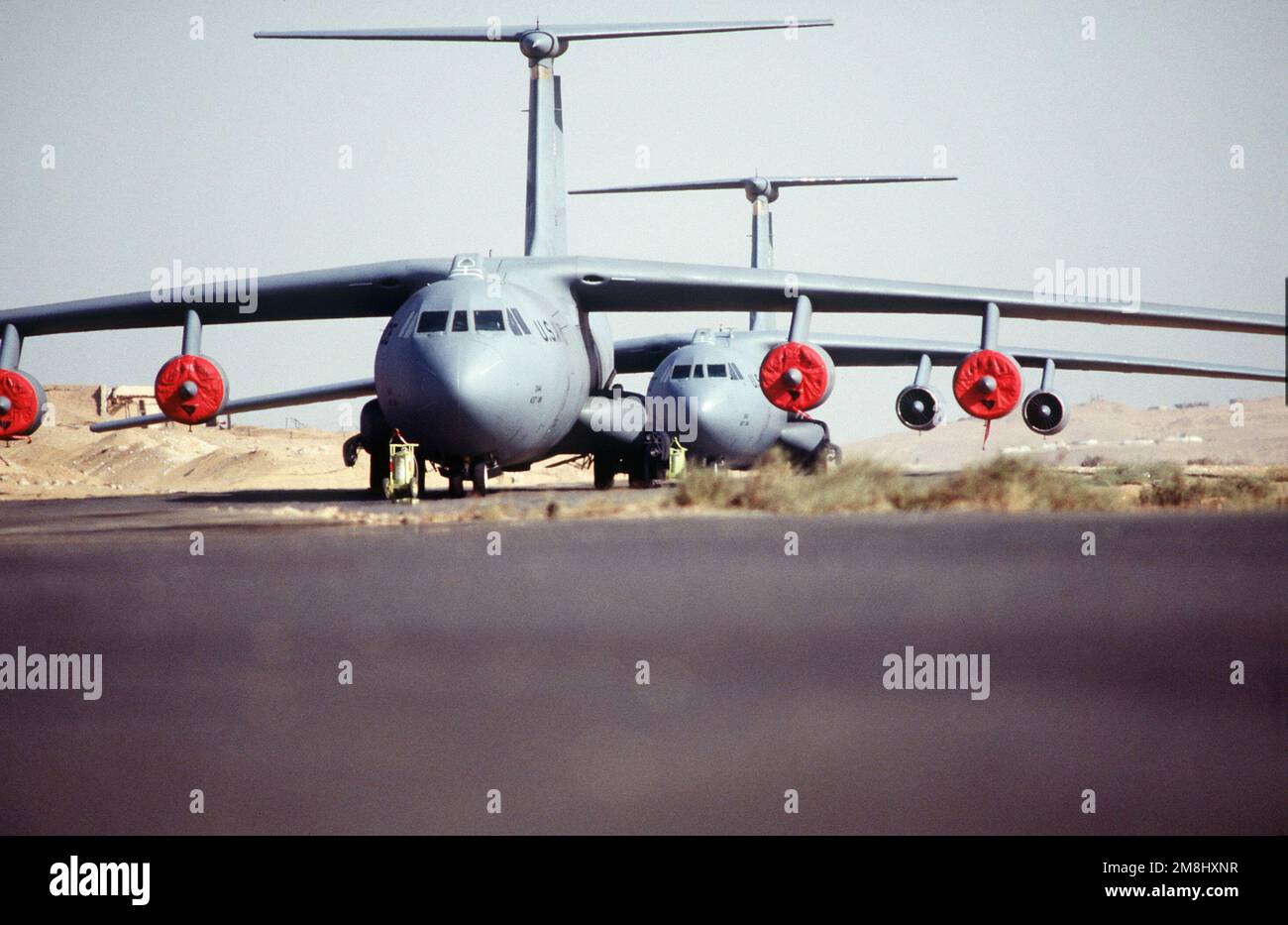C-141s are lined up on the flight line, soon to be on their way to ...