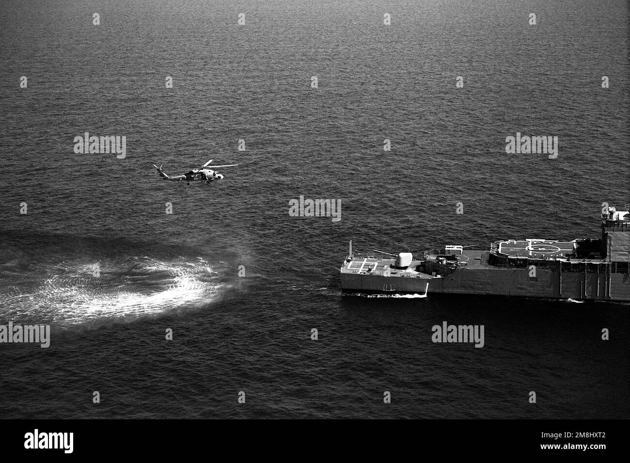 An SH-60 Seahawk helicopter approaches the fantail of the Spruance ...