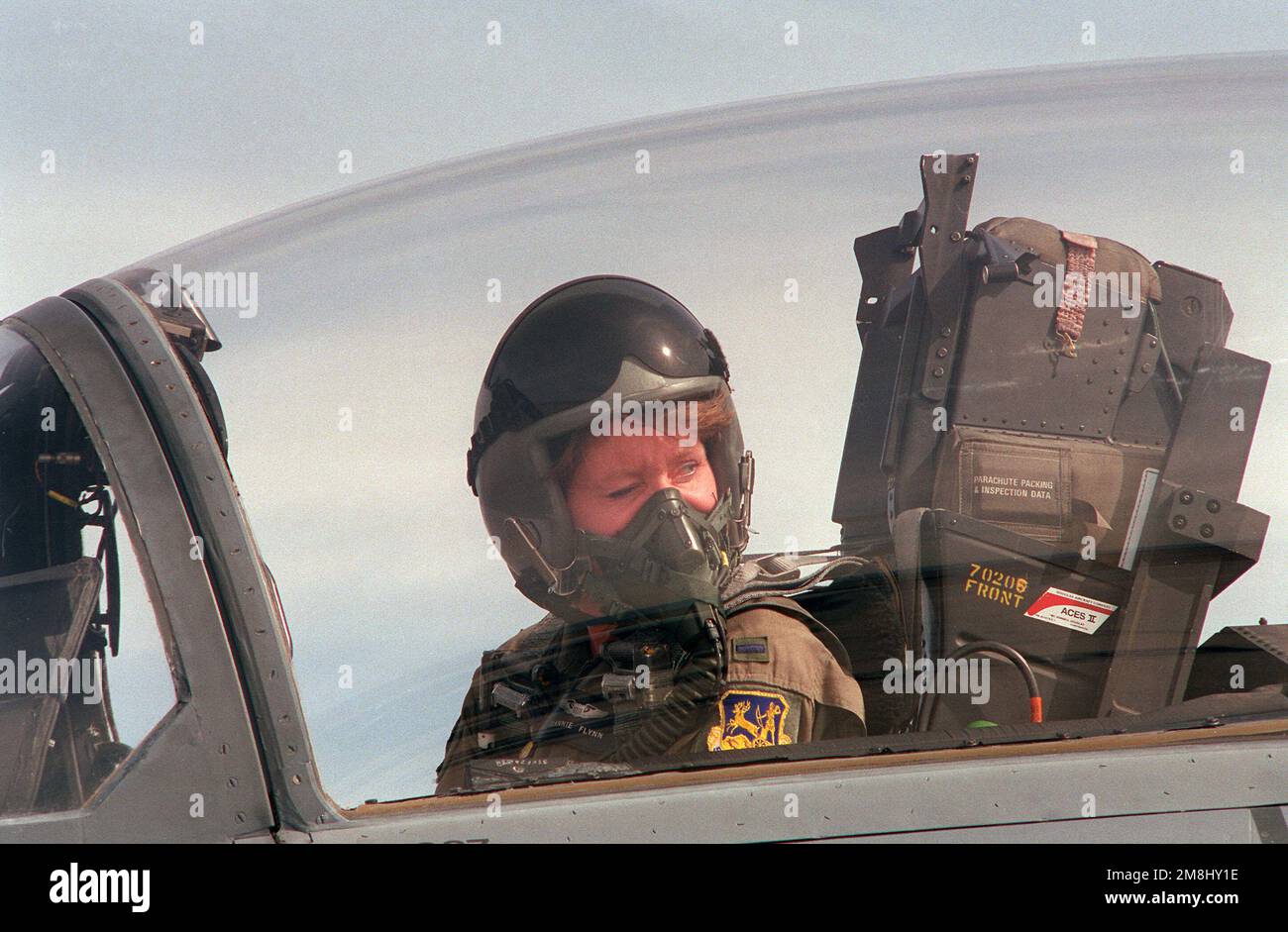 A close up of 1ST LT. Jeannie Flynn, the first F-15E female pilot, sits ...