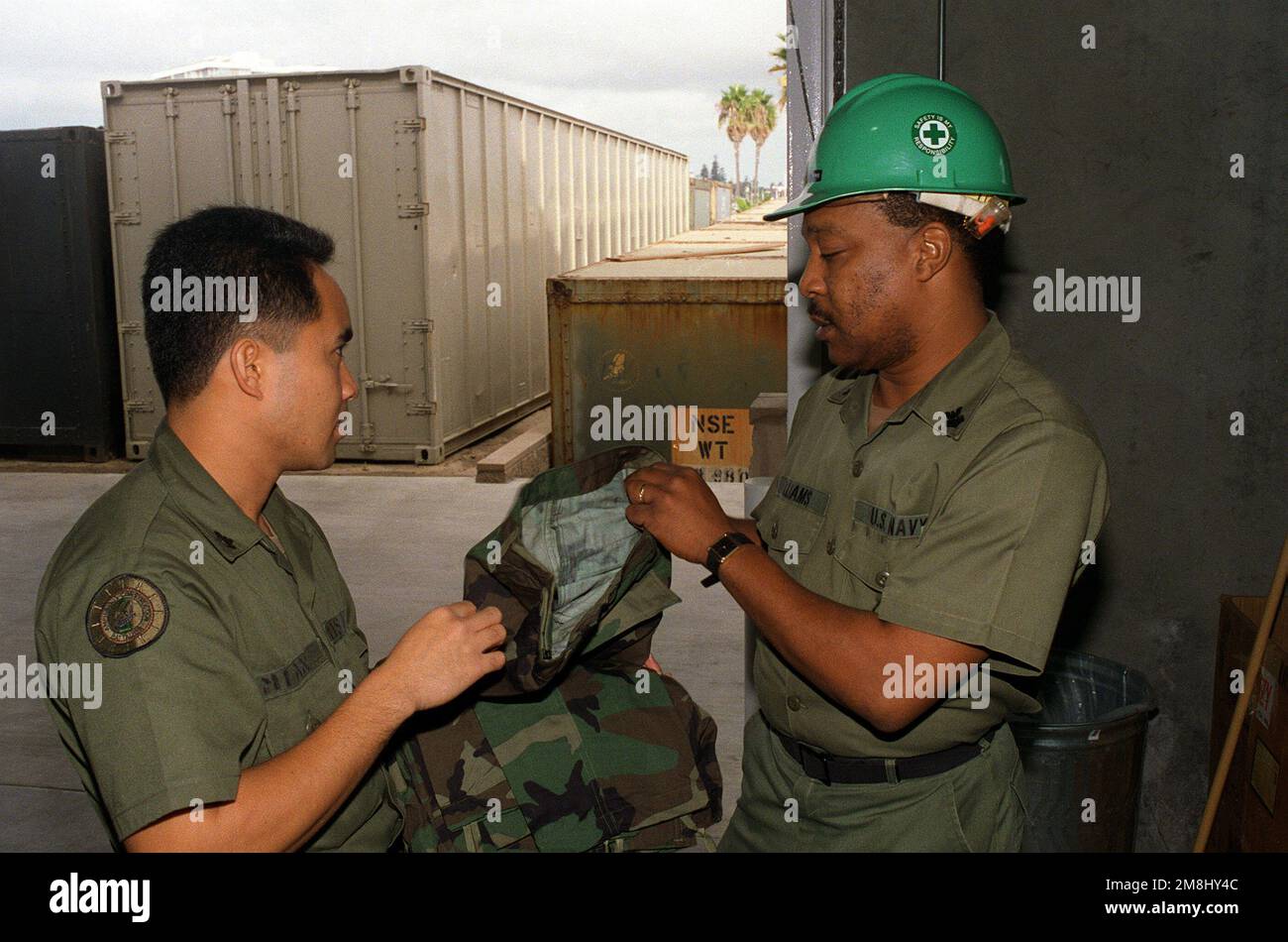 Ships Serviceman Third Class (SH3) Mian hands over new camouflage ...