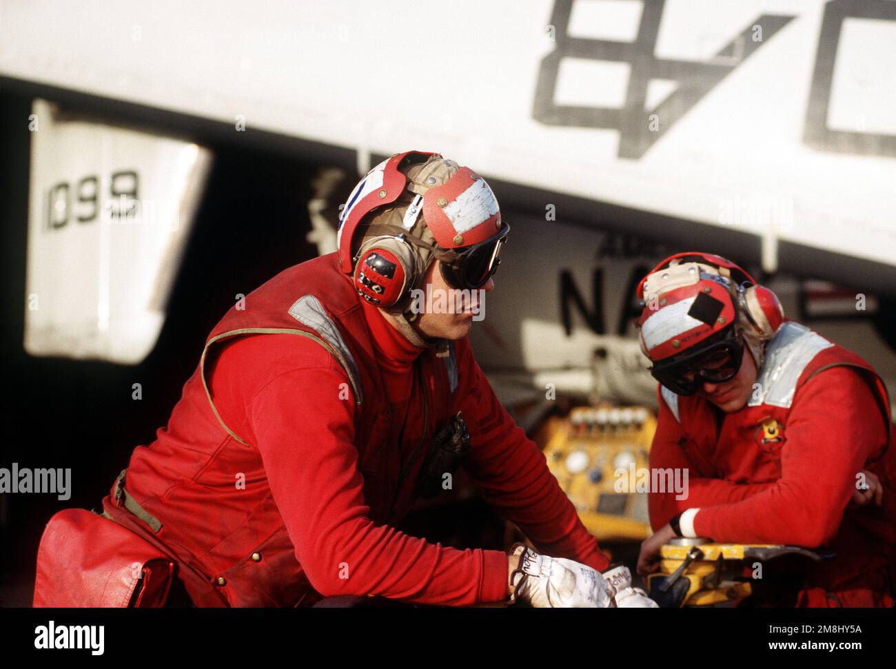 Weapons crewmen take a break between aircraft sorties on board the ...