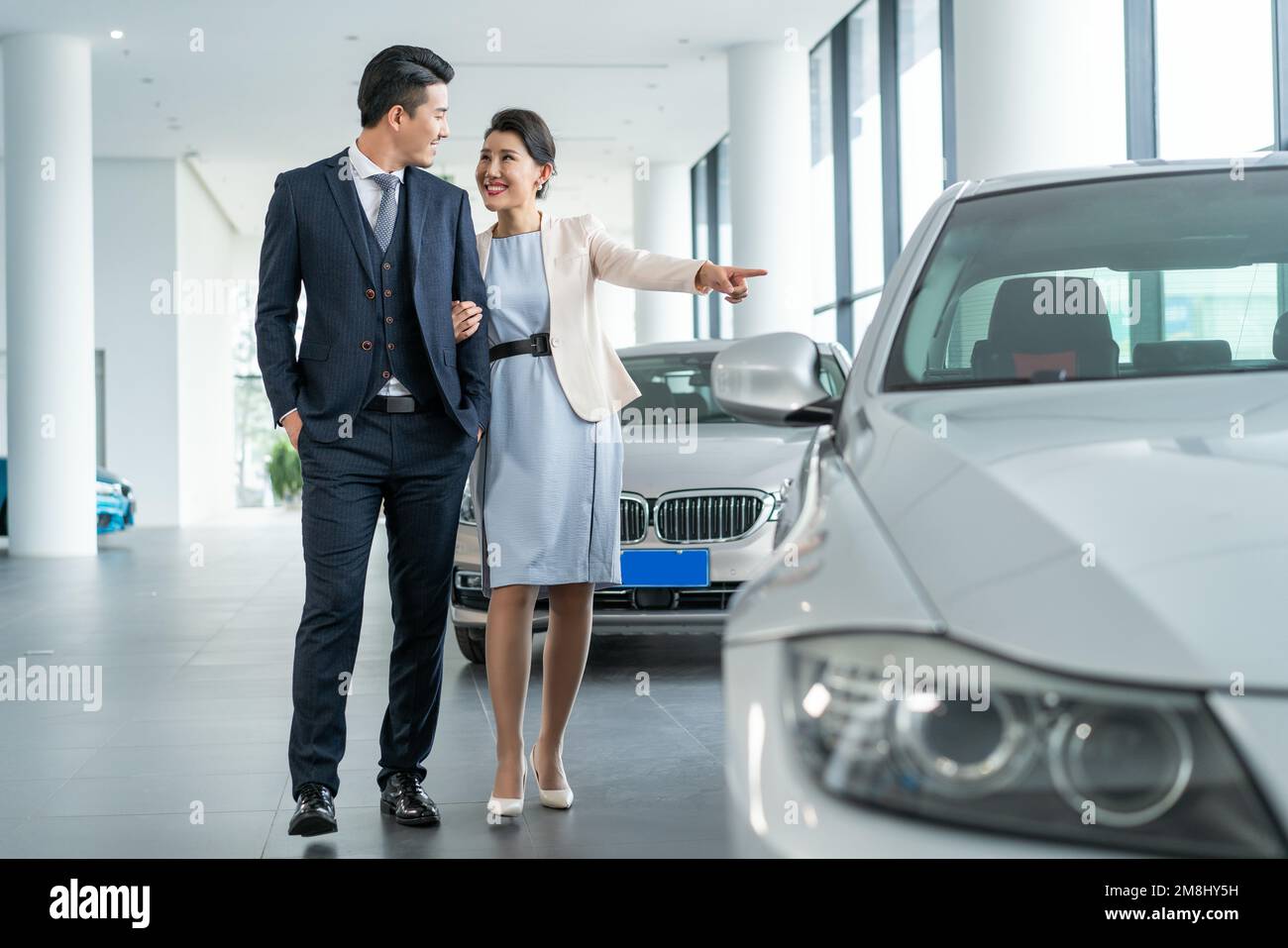 A young couple of choose and buy cars Stock Photo - Alamy