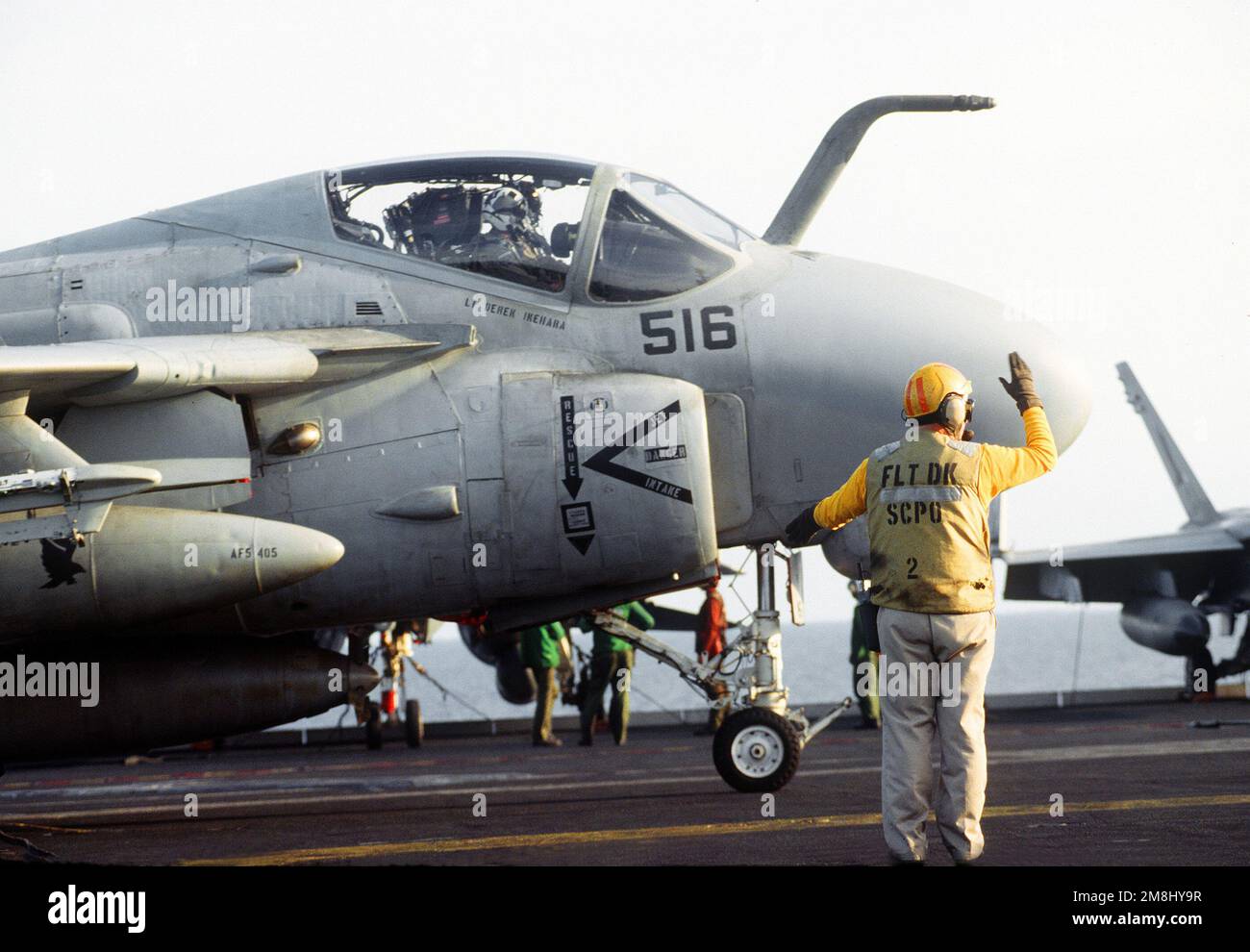 An A-6E Intruder aircraft of Attack Squadron 85 (VA-85) stands by on ...