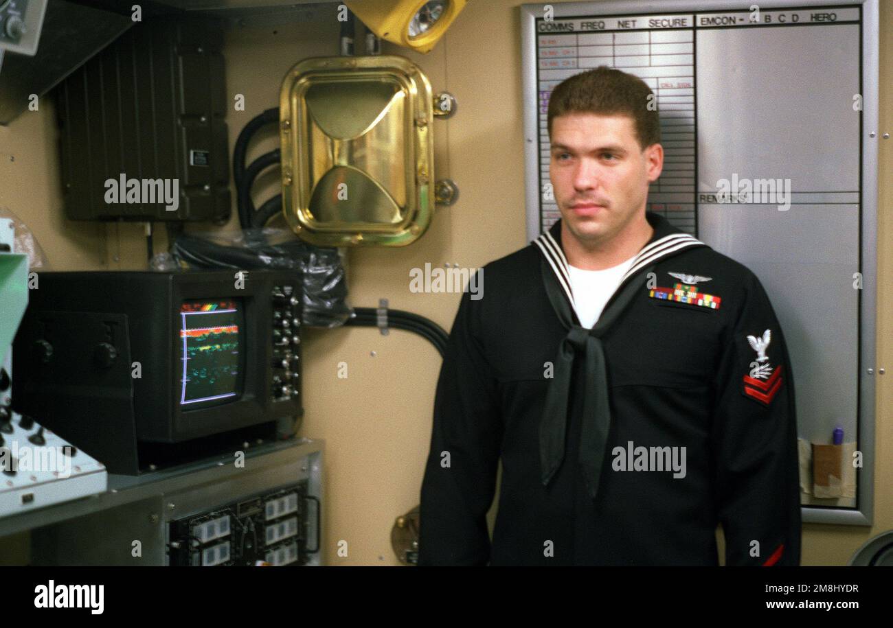 Radioman 2nd Class Steven Tate explains the operation of combat ...