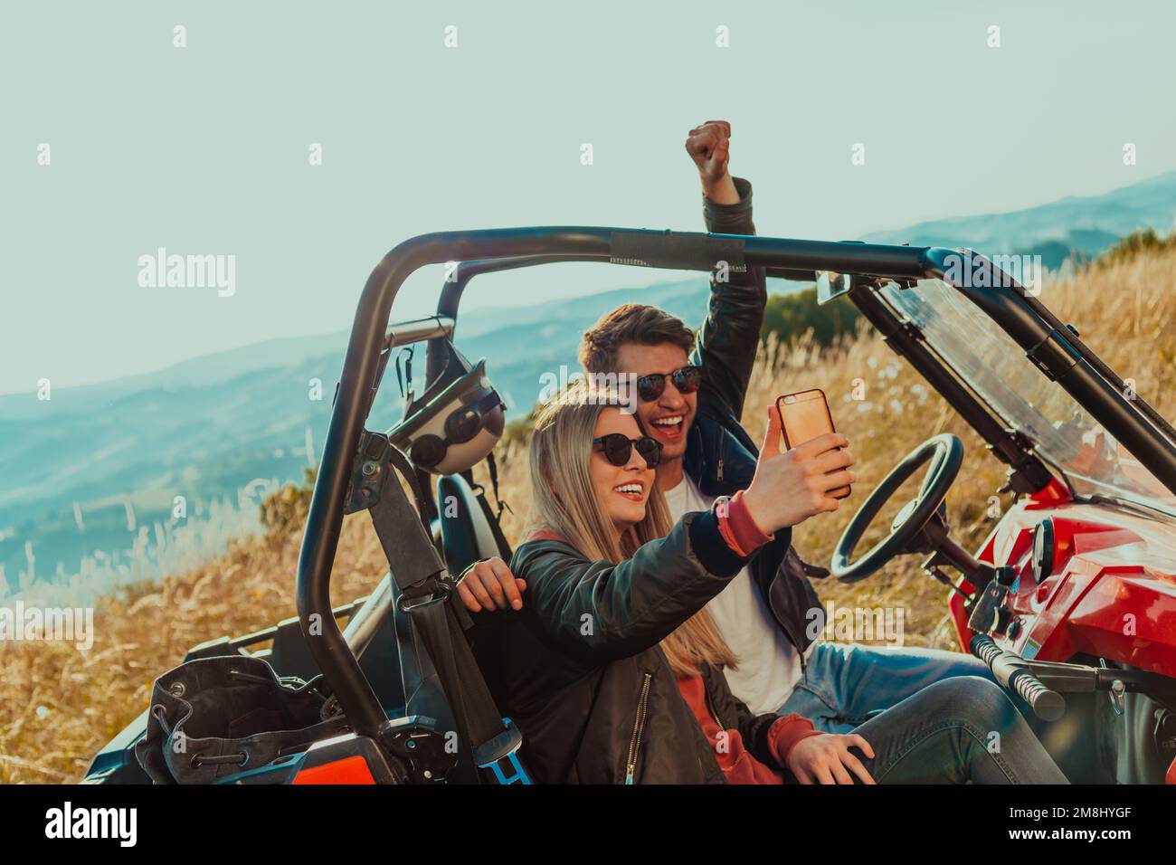 Young happy excited couple enjoying beautiful sunny day taking selfie ...