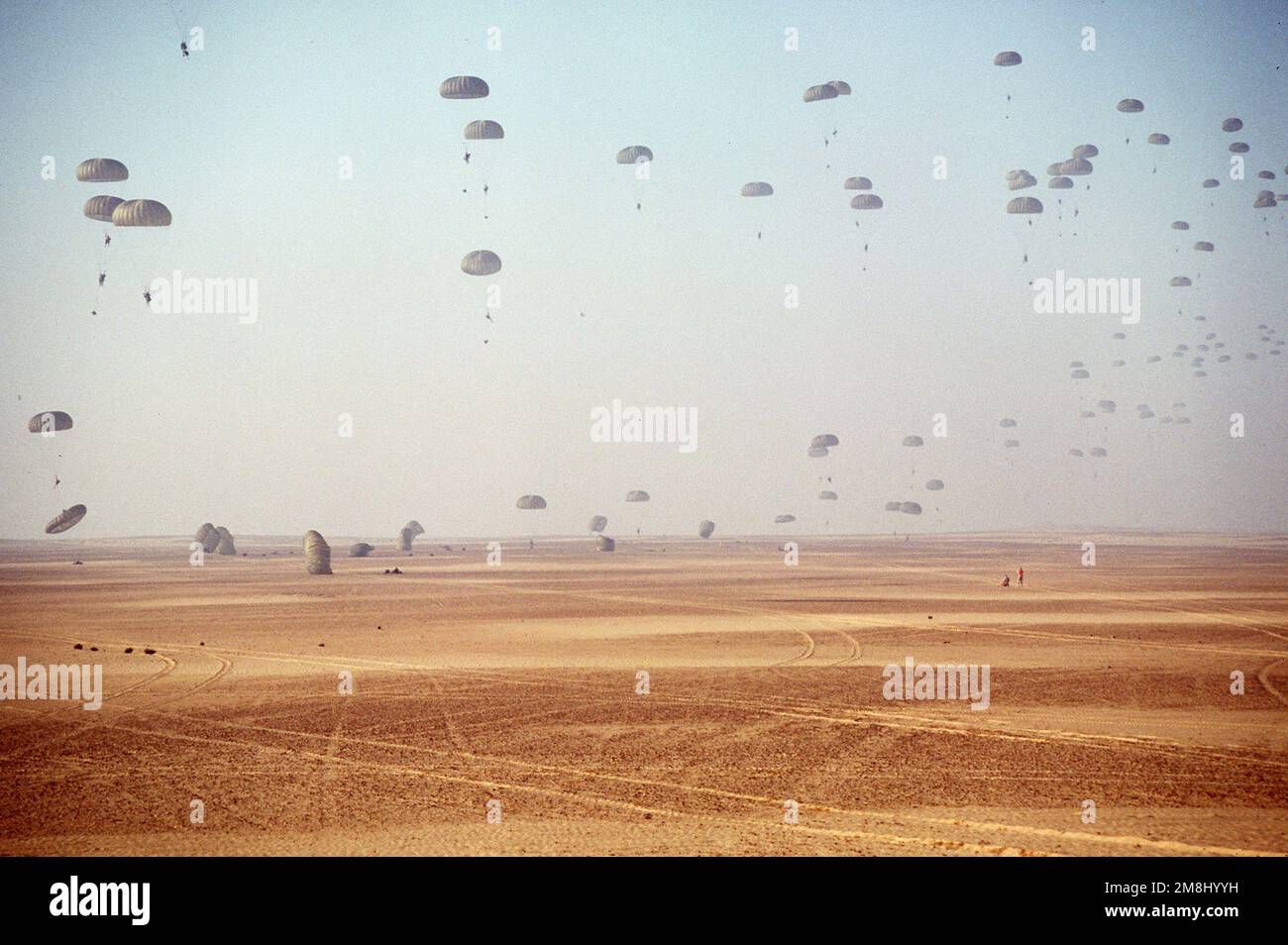 US Air Force and Army personnel perform a mass airborne drop with the ...