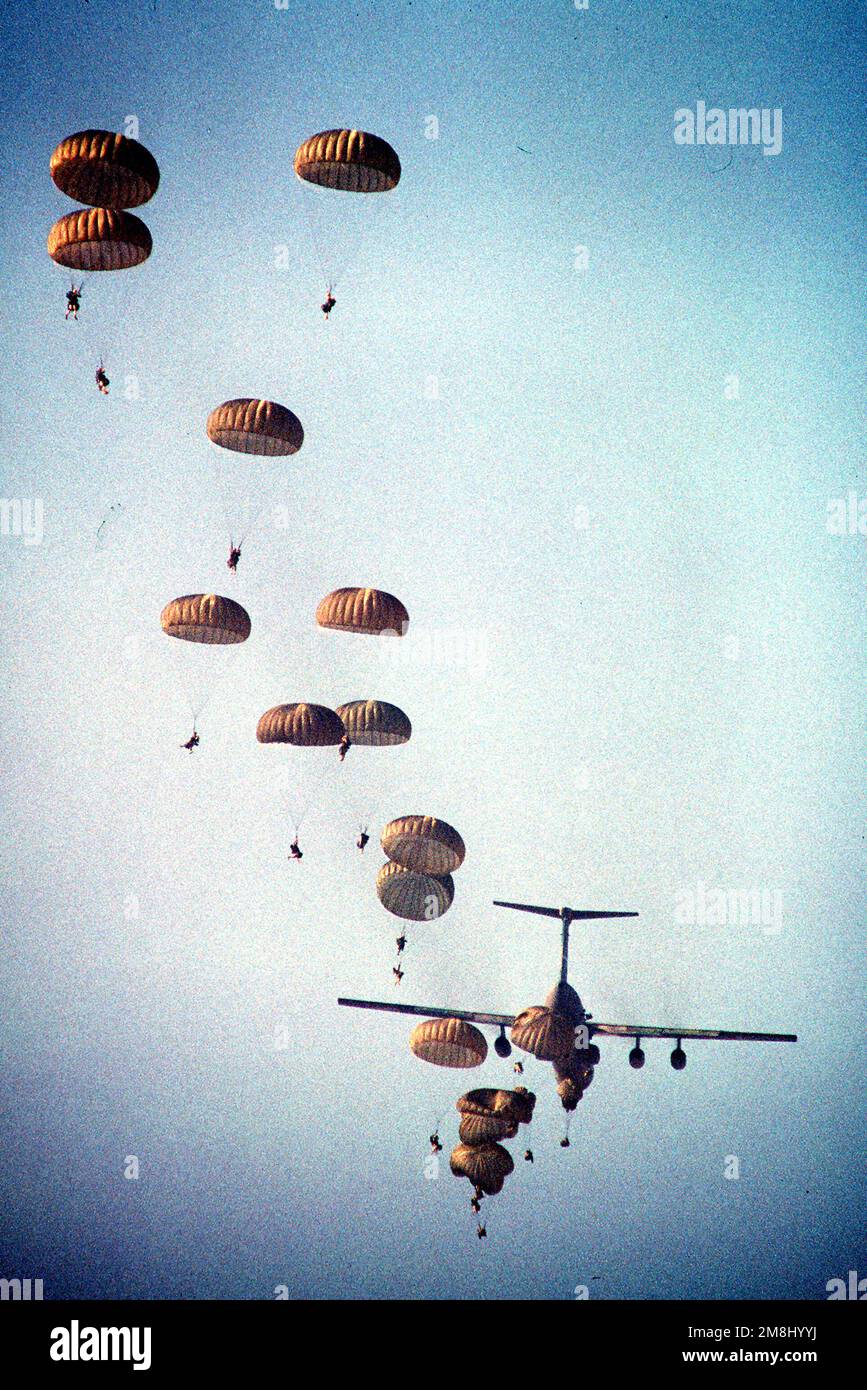 US Air Force and Army personnel perform a mass airborne drop with the ...