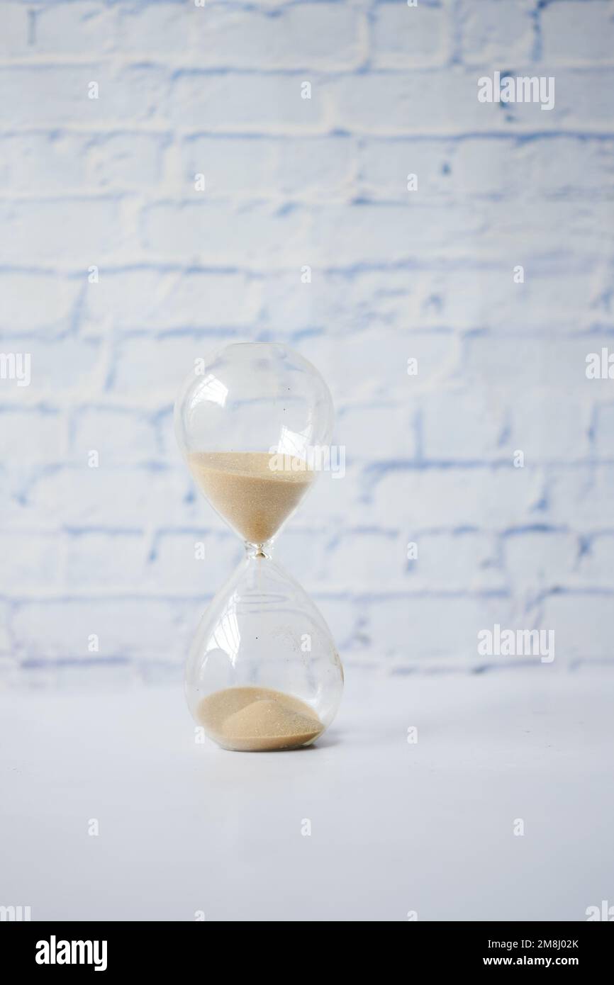 hourglass on table, sand flowing through the bulb of sandglass Stock ...
